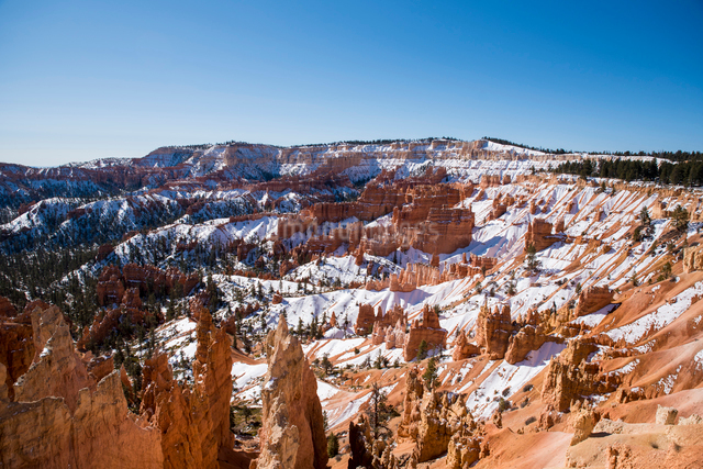 Scenic view of rock formations on snowy desert against clear sky during ...