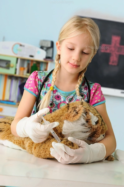 Girl pretending to be vet giving toy tiger syringe injection during ...
